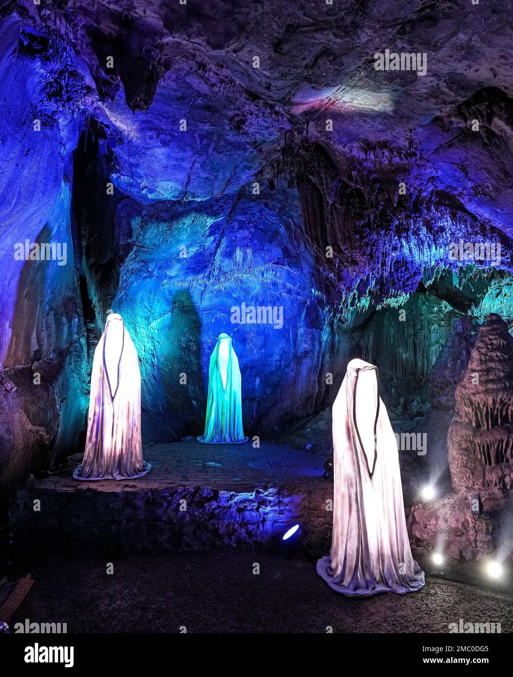 People visit the colorful illuminated Dechen Cave in Iserlohn, Germany ...