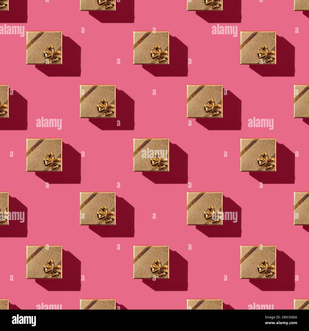 Seamless pattern of golden gift box over red pink background. Repeating ...