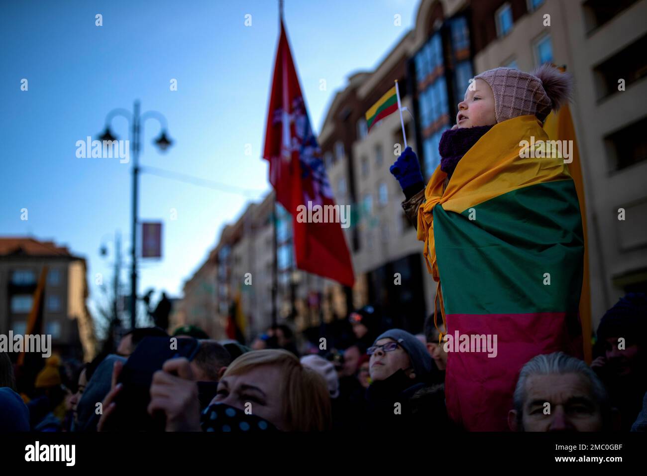 A girl is covered with the Lithuanian flag during a celebration of ...