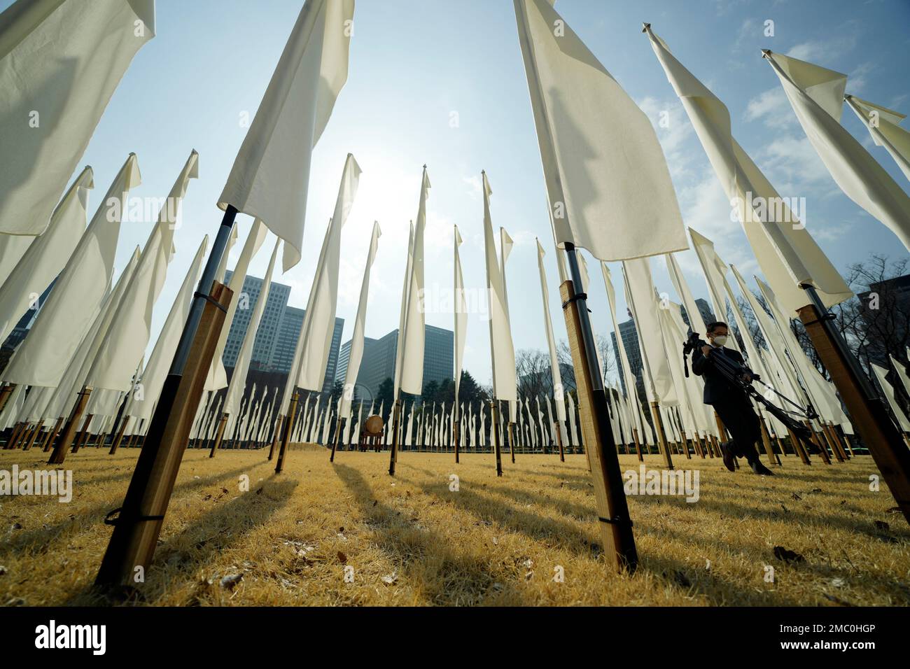 A journalist walks though 311 flags to mourn for the victims of the ...