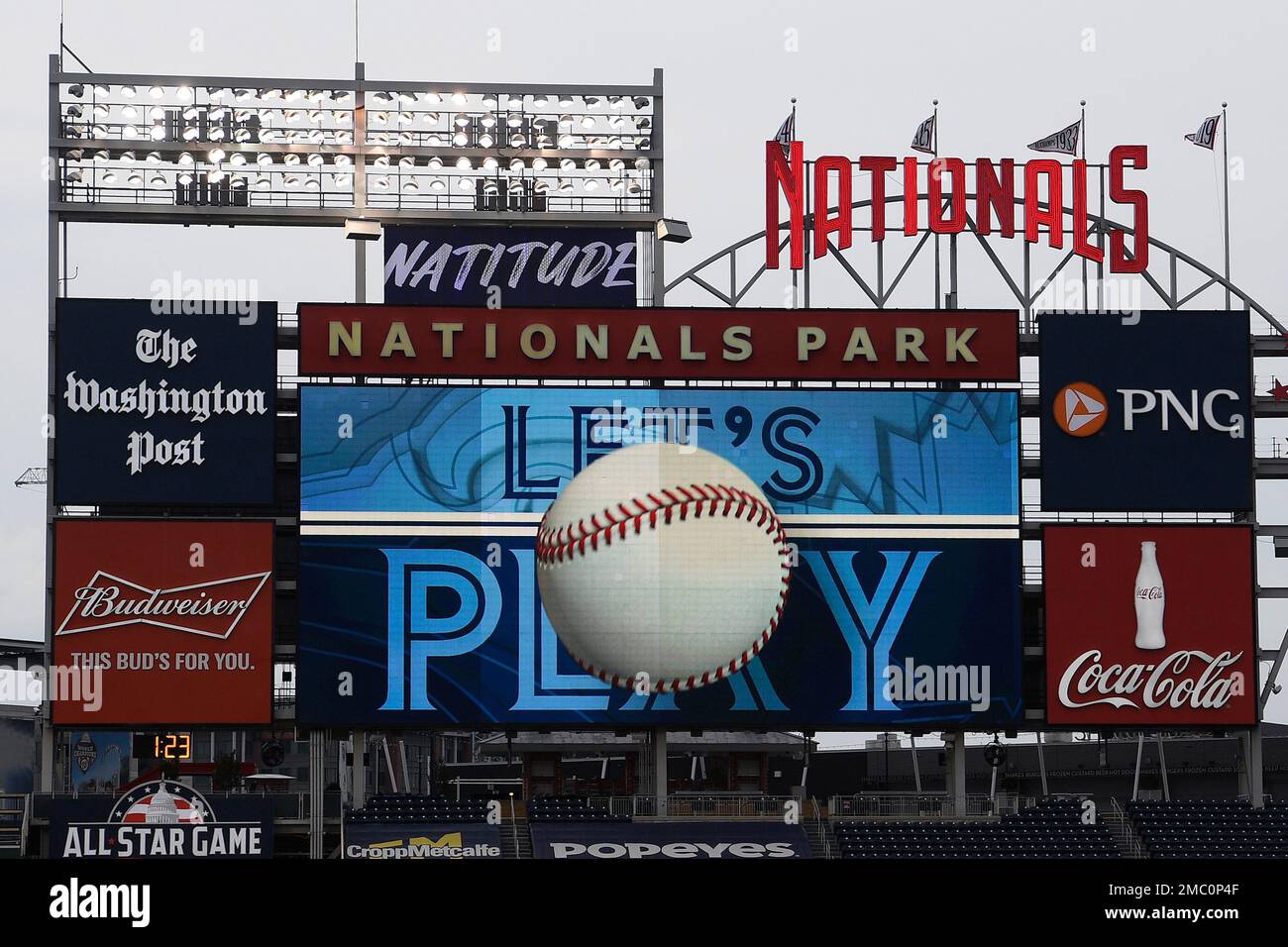 FILE - The scoreboard plays the seventh inning stretch themes of the ...