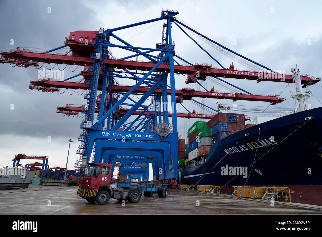 Gantry cranes move containers onto transporters at the port, in Beirut ...