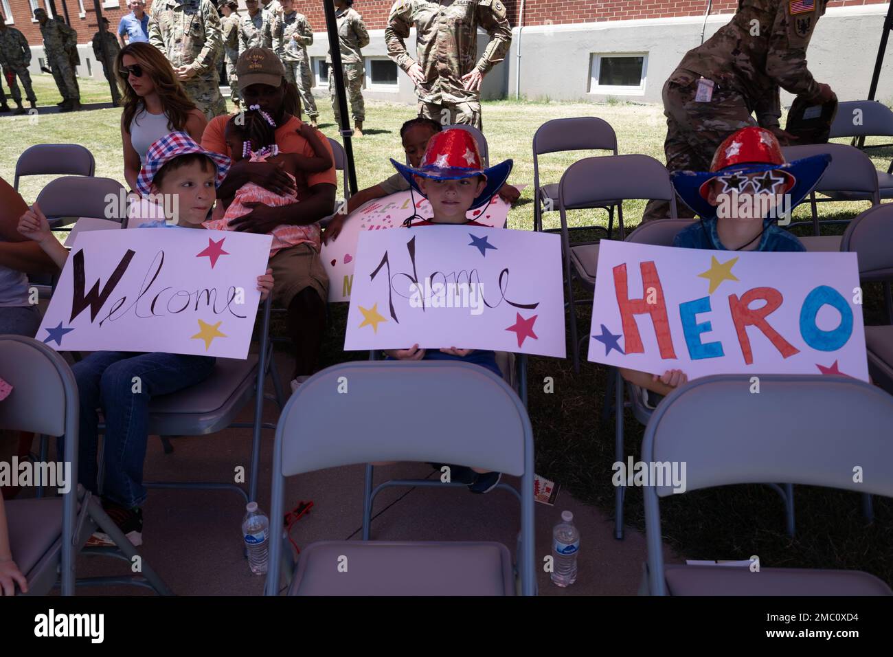 Children show their handmade signs welcoming home Soldiers and ...