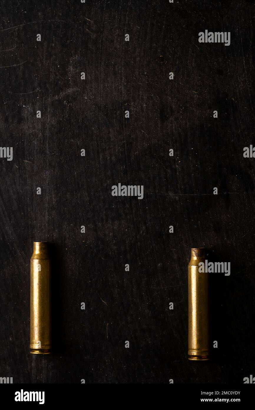 Empty rifle bullet cartridges lying on the black background Stock Photo ...