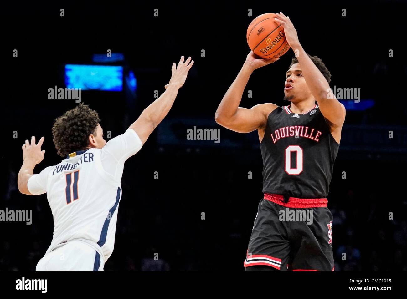 Louisville's Noah Locke (0) shoots over Virginia's Malachi Poindexter ...