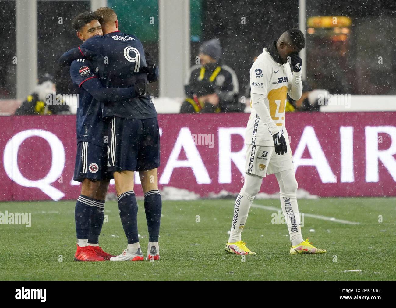 New England Revolution forward Adam Buksa (9) hugs midfielder Brandon ...
