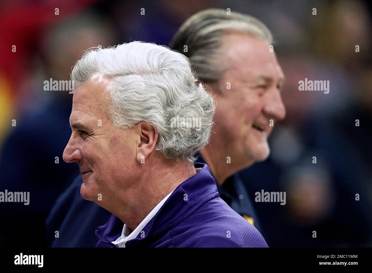 Kansas State coach Bruce Webber, front, passes West Virginia coach Bob ...