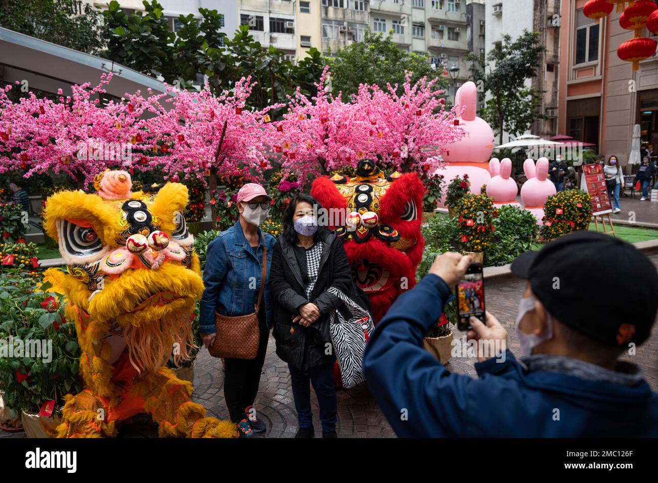 People pose for a photo in front of the Chinese lions in the Wan Chai ...