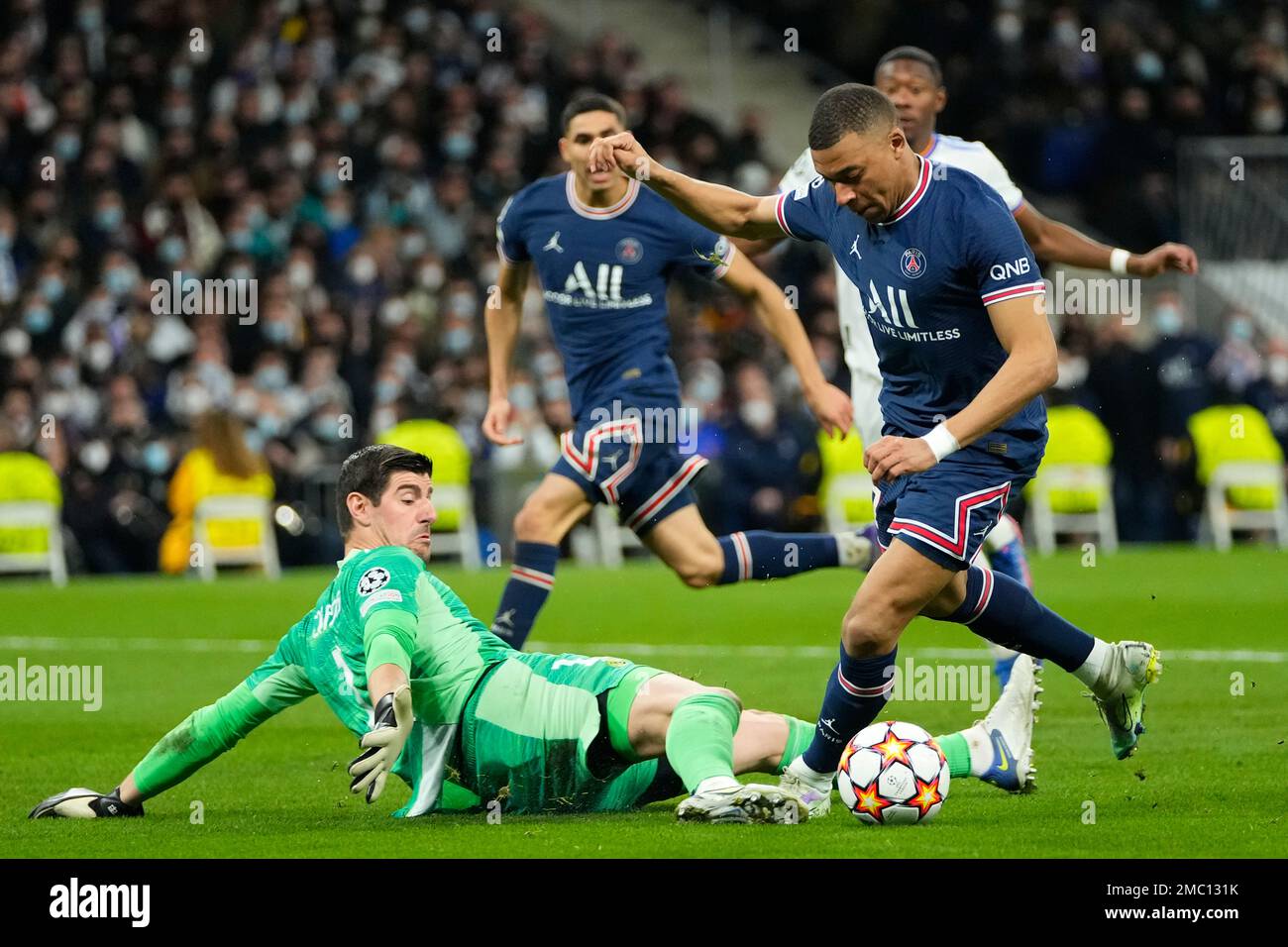 PSG's Kylian Mbappe passes Real Madrid's goalkeeper Thibaut Courtois ...