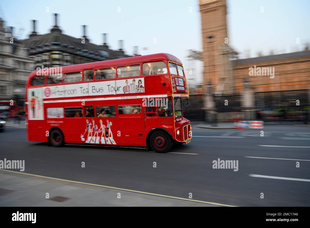Red double-decker bus at the Houses of Parliament, Westminster, London ...