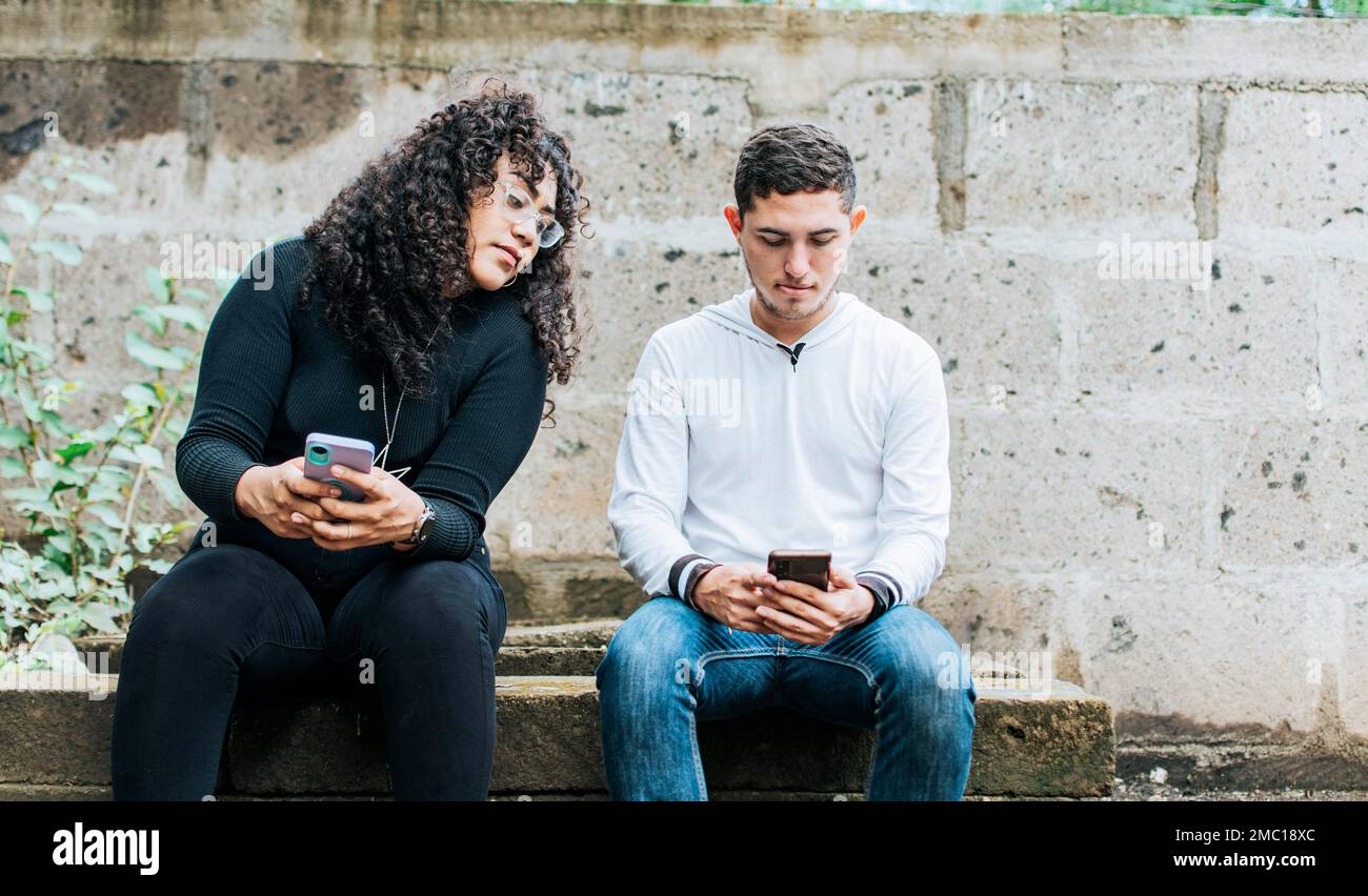 Suspicious person spying on her boyfriend phone. Jealous girl spying on her boyfriend cell phone ...