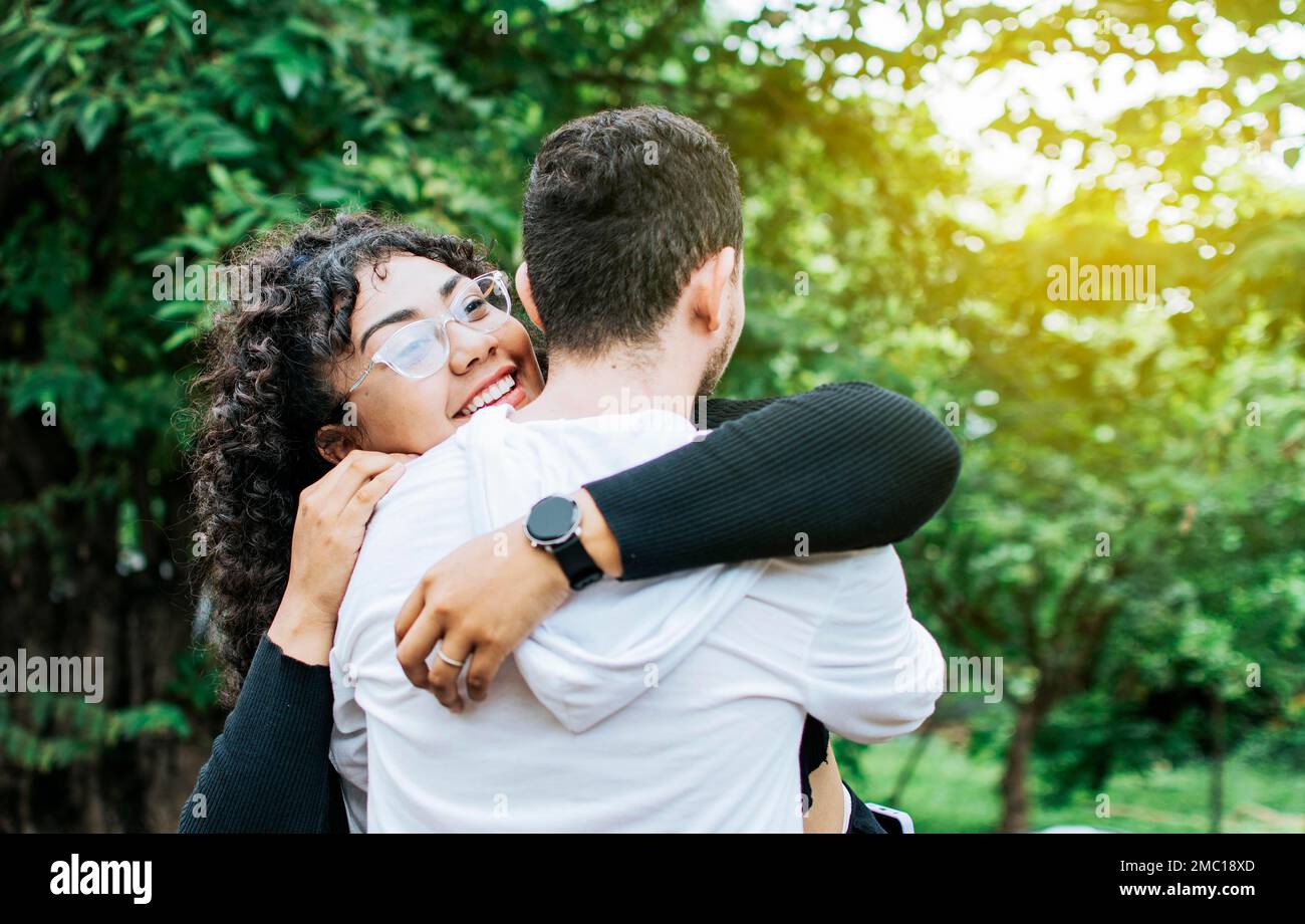 Close up of smiling teenage couple hugging, Teenage couple hugging ...