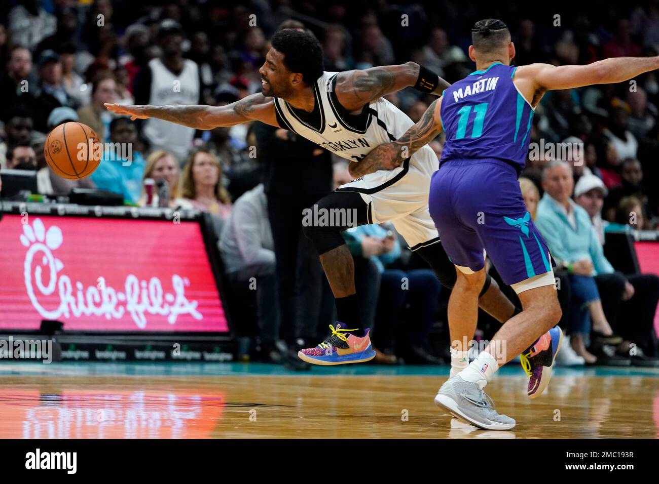 Brooklyn Nets guard Kyrie Irving is fouled by Charlotte Hornets forward ...