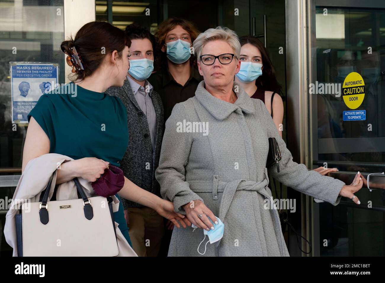 Nicole Reffitt, center, walks out of federal court in Washington ...