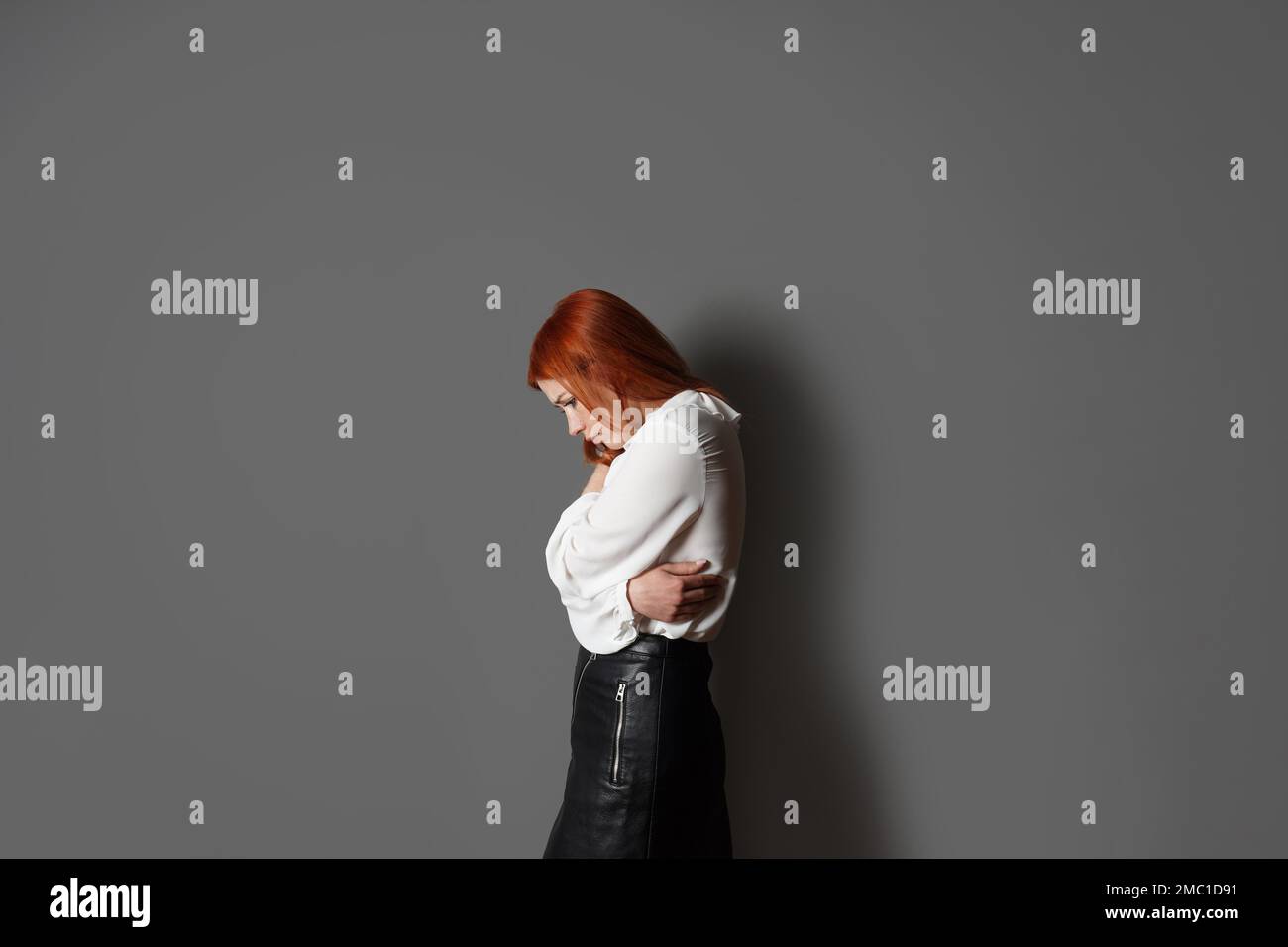 sad woman feeling lonely and depressed against gray background with ...