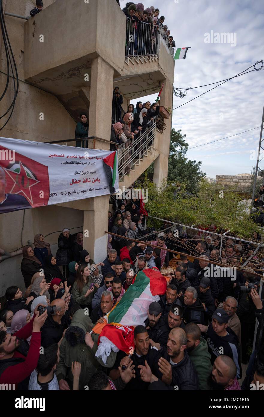 Mourners carry the body of Palestinan Yamen Nafez Jafal, 16, during his ...