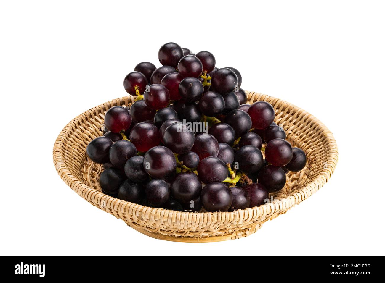 Bunch of ripe purple grapes in bamboo basket isolated on white ...