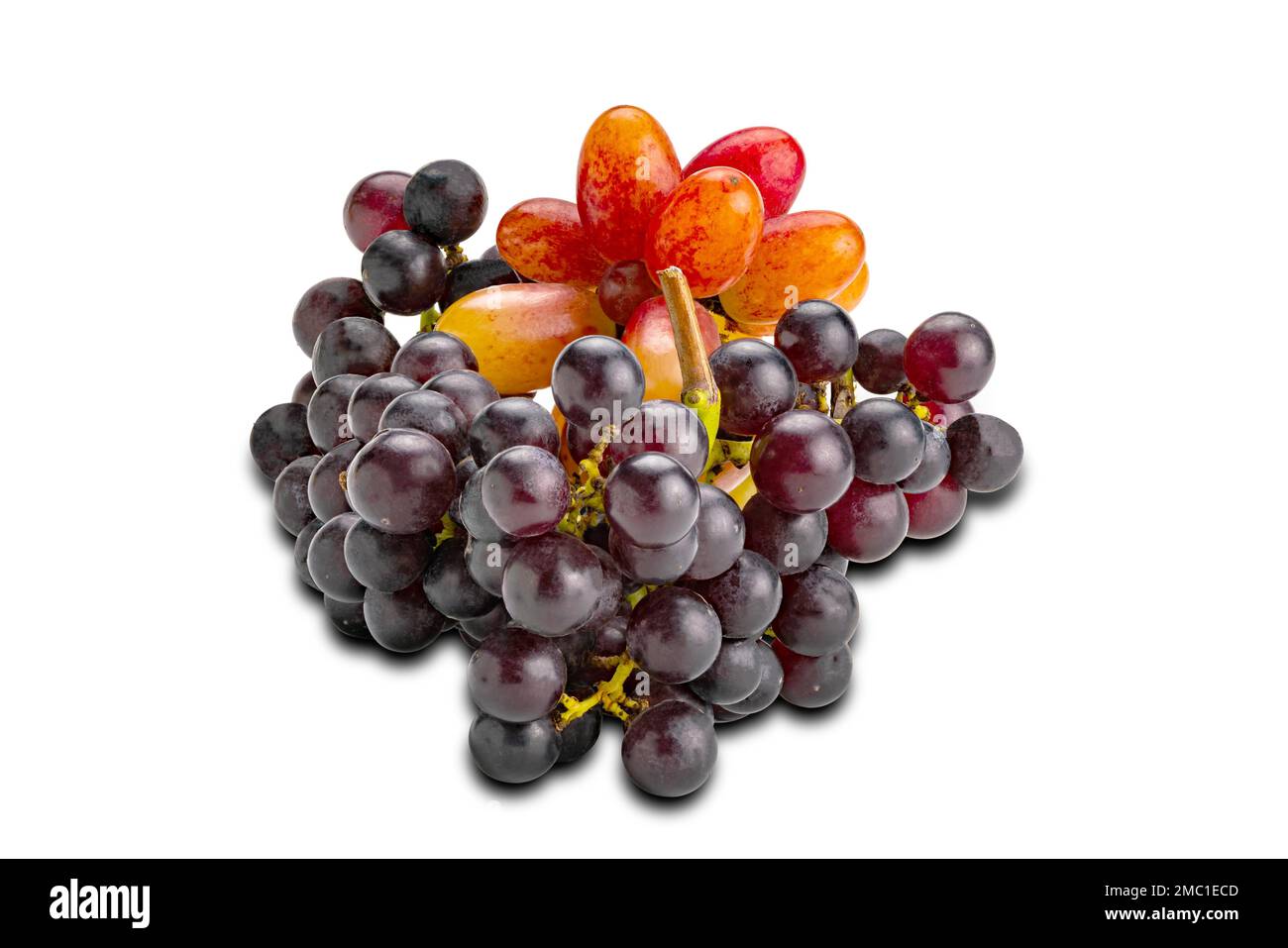 Bunches of freshly harvested ripe red grapes, purple grapes, isolated on white background with ...