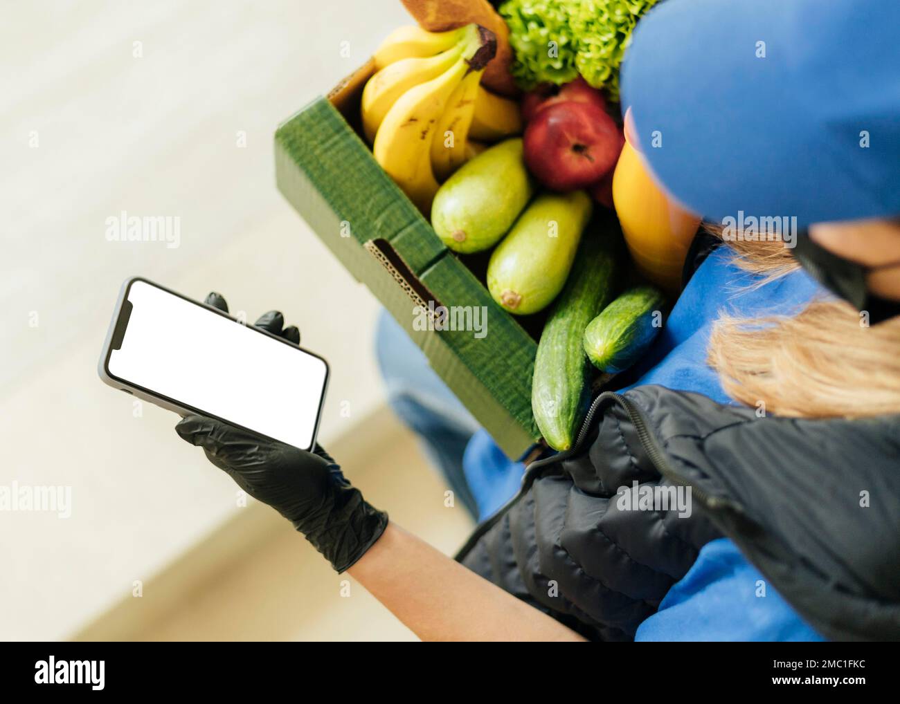 Close up woman holding food crate Stock Photo - Alamy