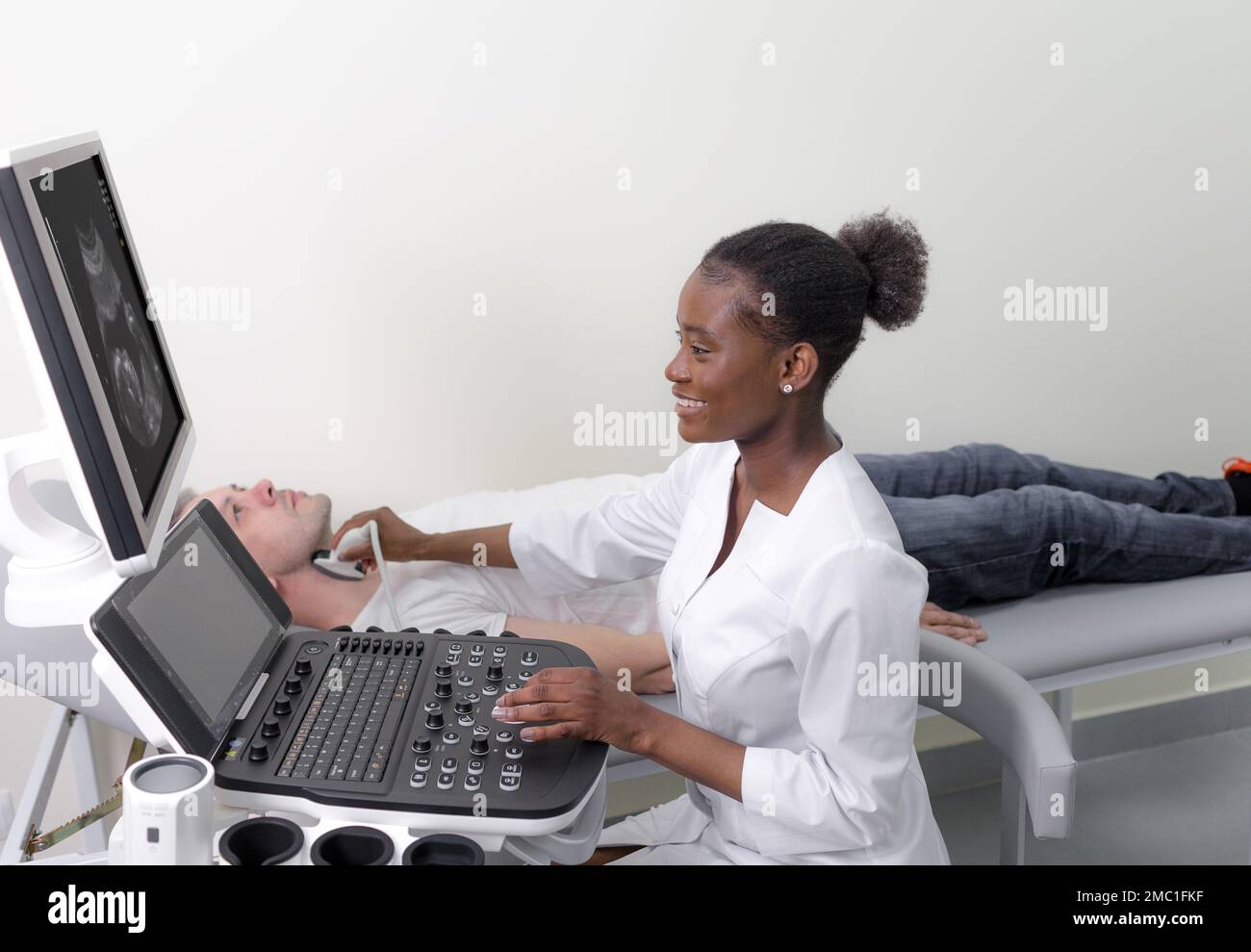 Ultrasound diagnostics of the thyroid gland of a man in the clinic, an ...