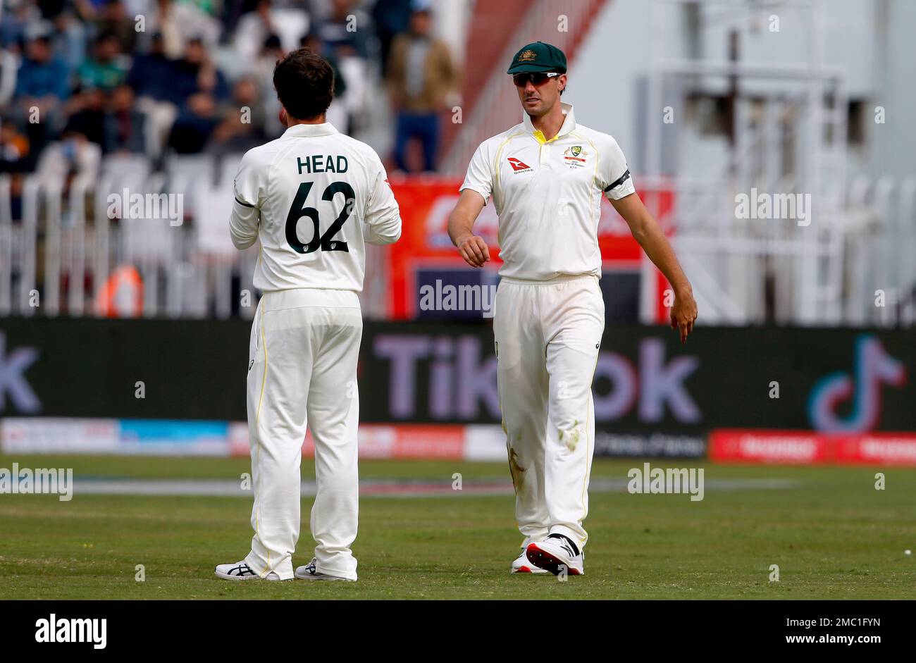 Australia's skipper Pat Cummins chats with teammate Travis Head during ...