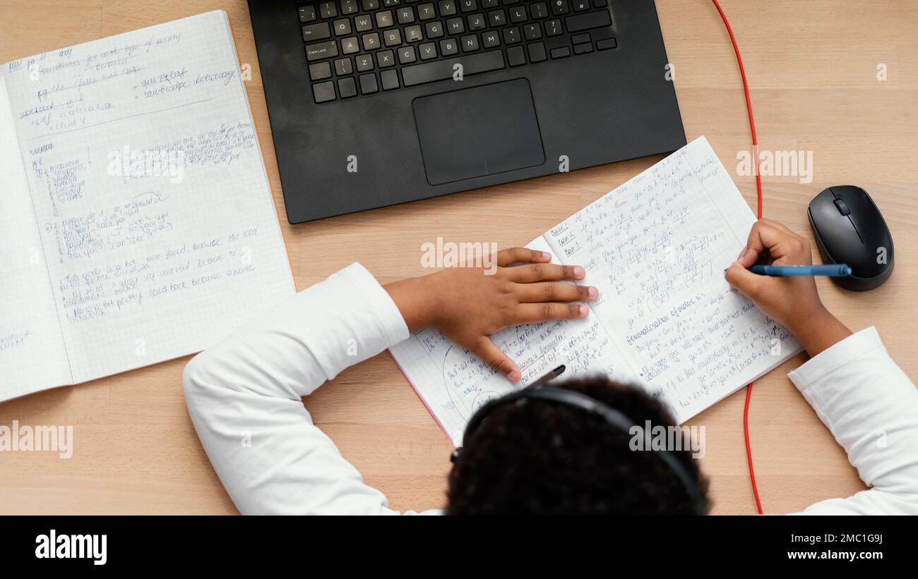 Boy doing homework with use laptop Stock Photo - Alamy
