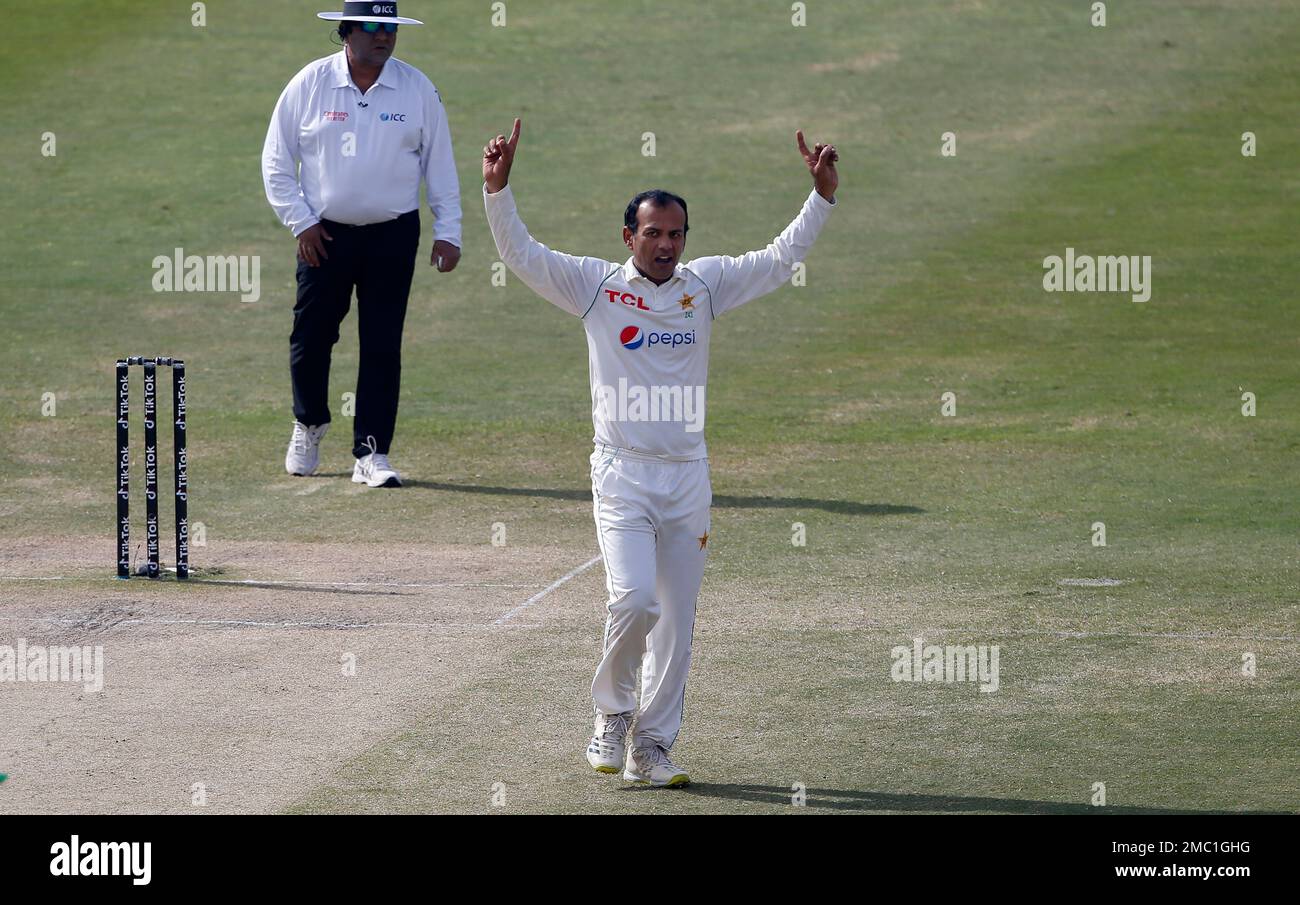 Pakistan's Nauman Ali, front, celebrates after taking the wicket of ...