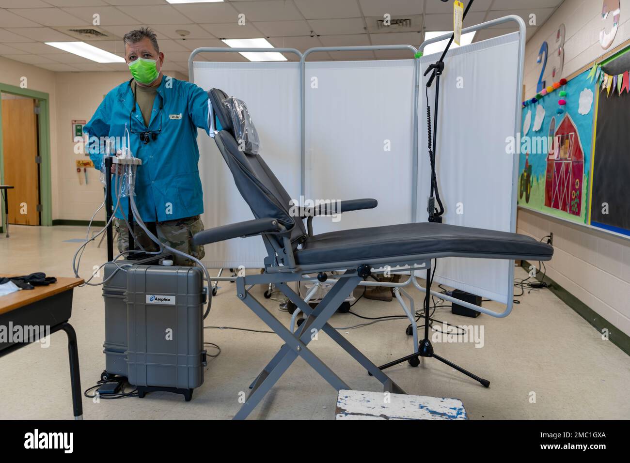 Lieutenant Colonel Rex Monif stands next to a dental chair he donated ...