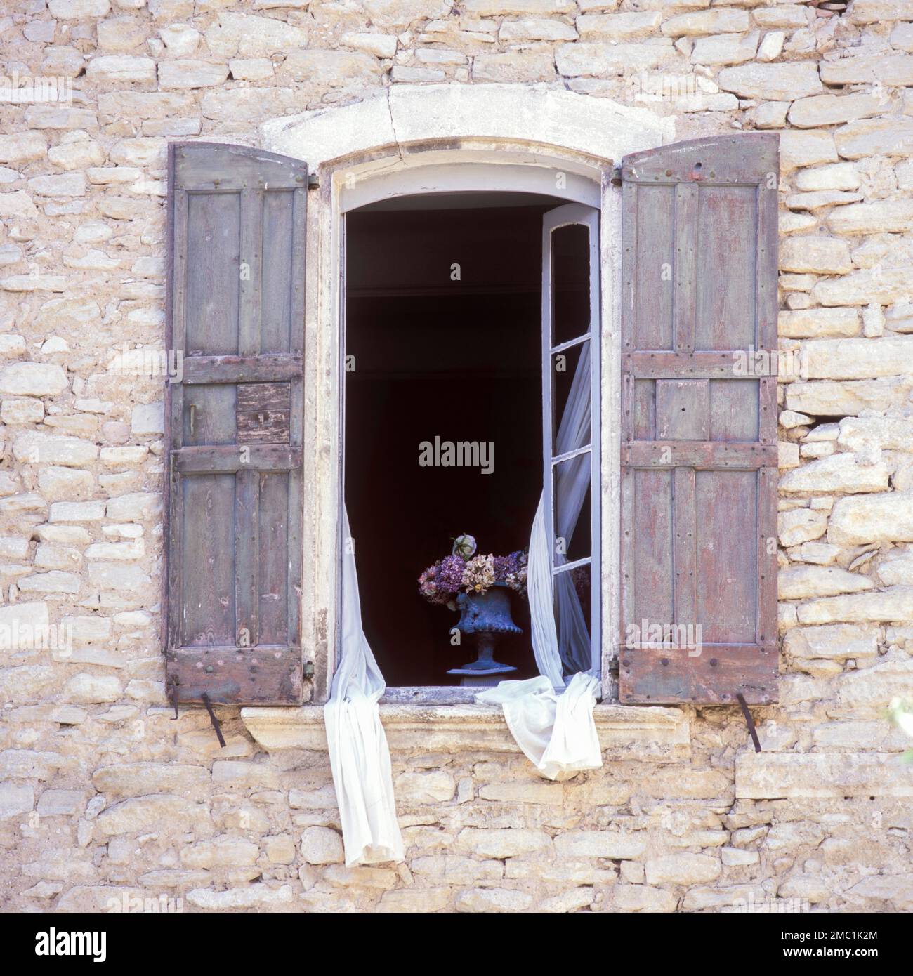 Opened window with shutters in a stone facade, Provence, France Stock ...