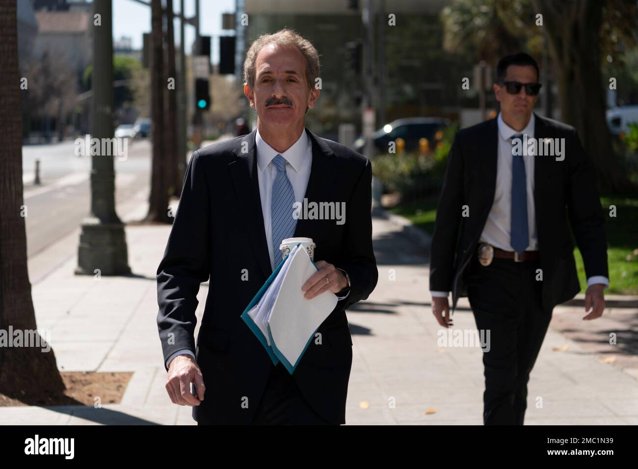 Los Angeles City Attorney Mike Feuer, left, walks back to his office ...