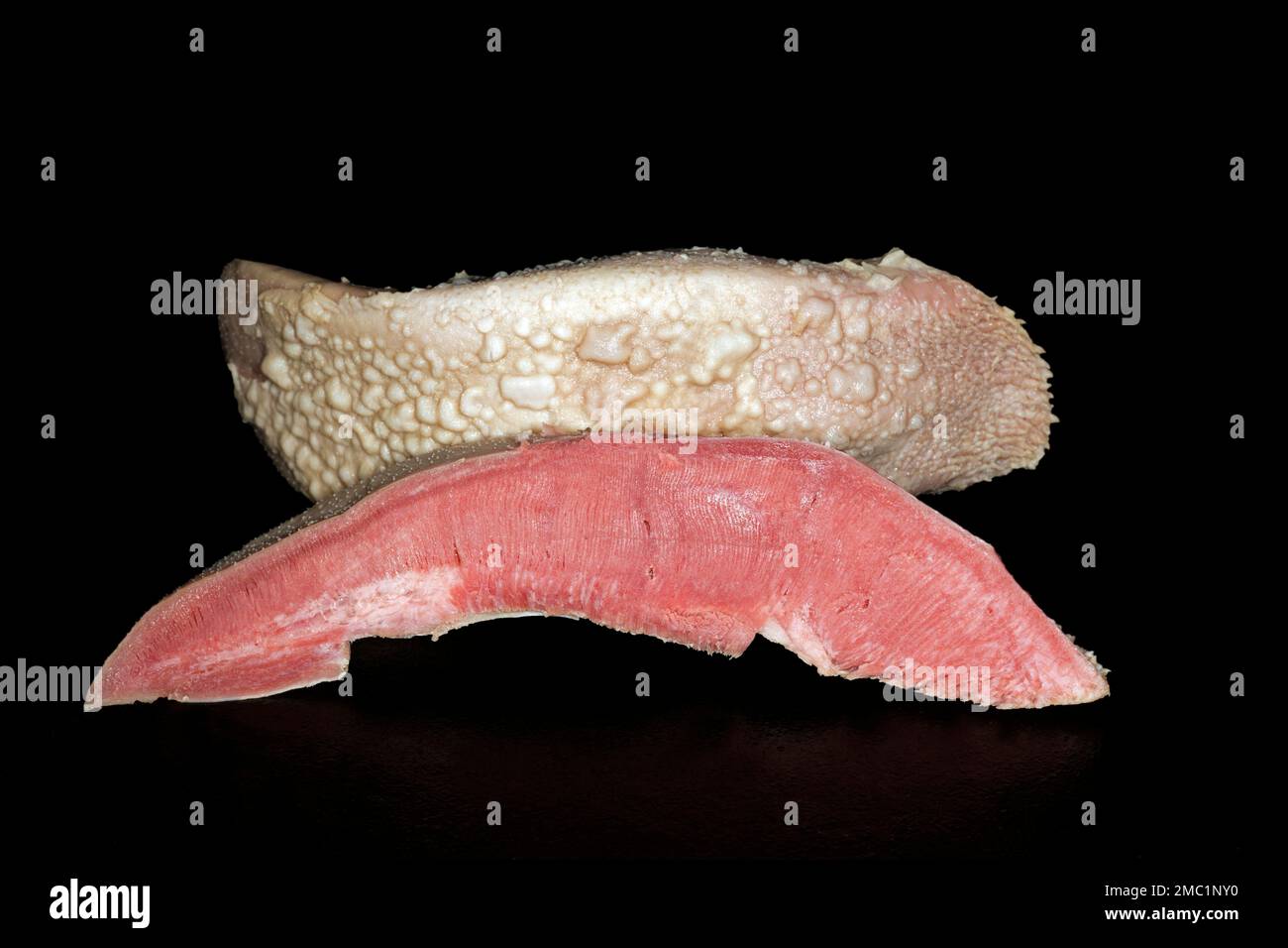 Cured cooked, halved and not yet peeled pork tongue, food photography ...