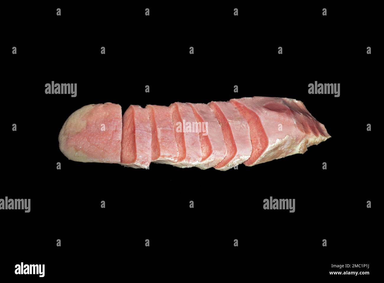 Cured, cooked and sliced pork tongue, food photography with black ...