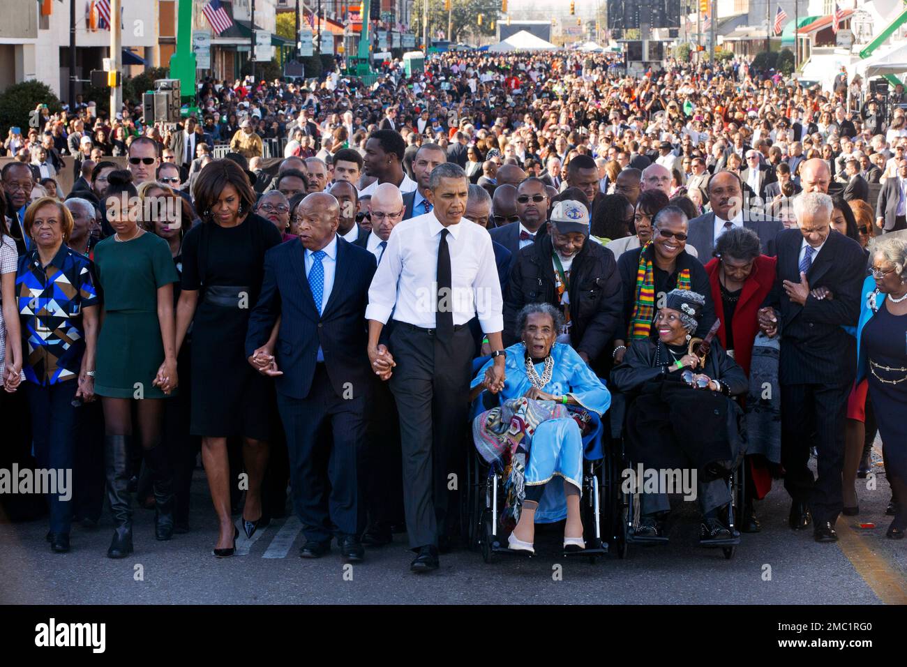 President Barack Obama, center, walks as he holds hands with Amelia ...