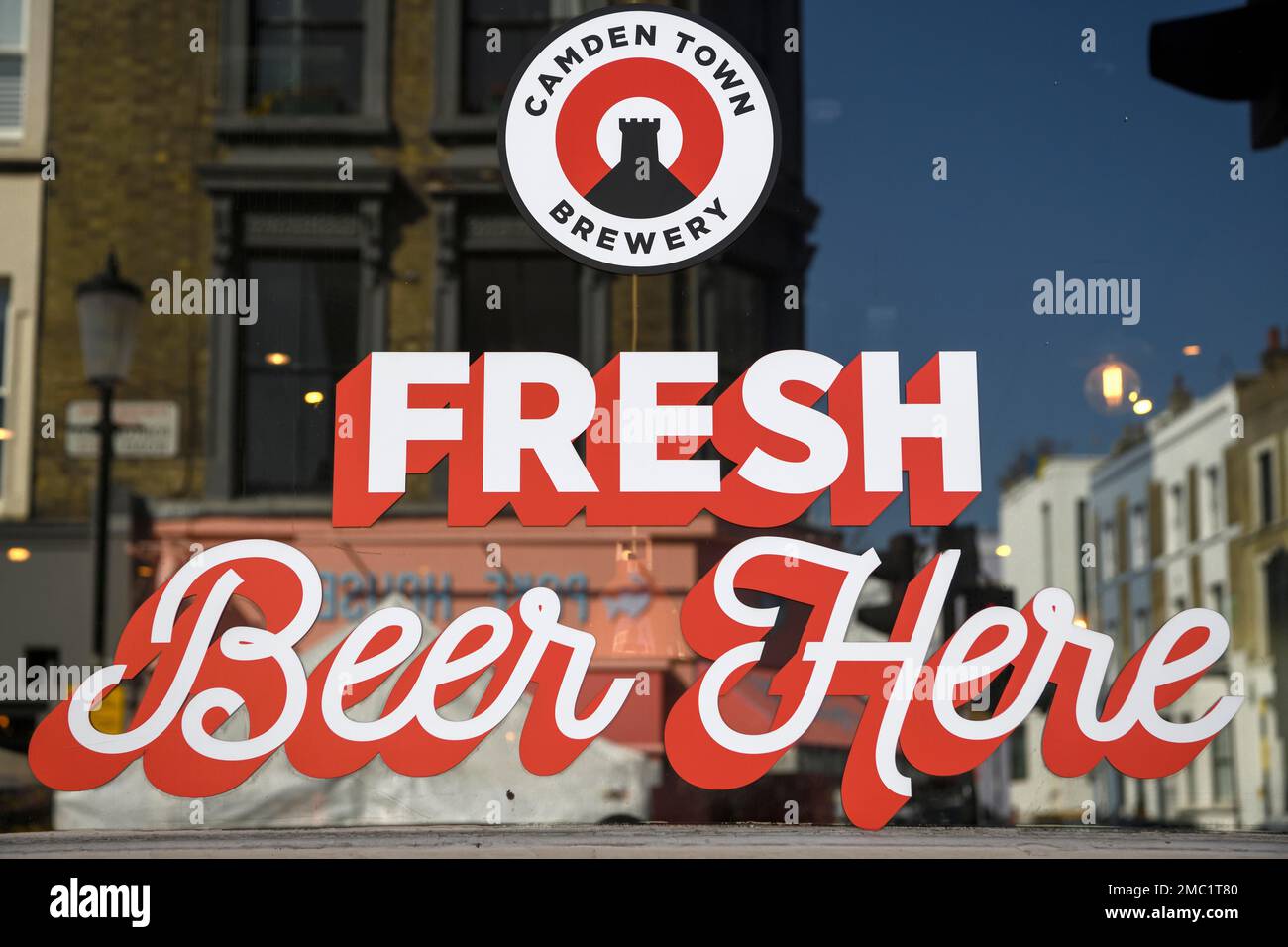 Beer advertisement on the window of a pub on Portobello Road, London ...