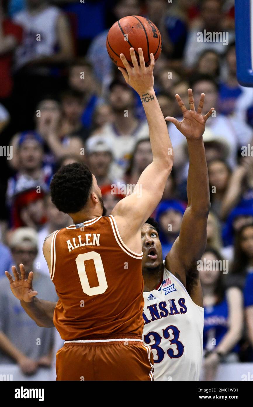 Texas forward Timmy Allen (0) takes a shot over Kansas forward David ...