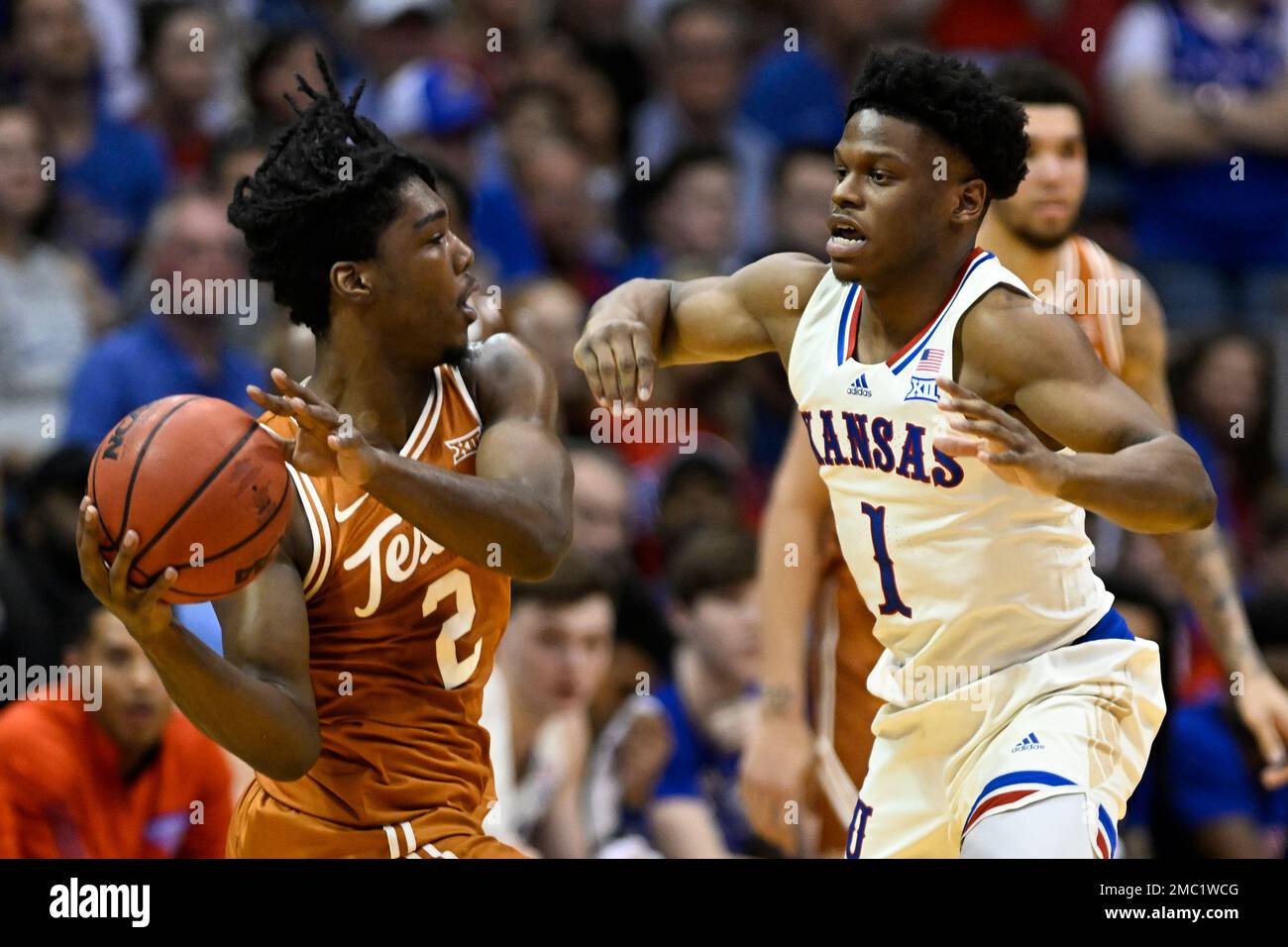 Texas guard Marcus Carr (2) looks to pass around Kansas guard Joseph ...