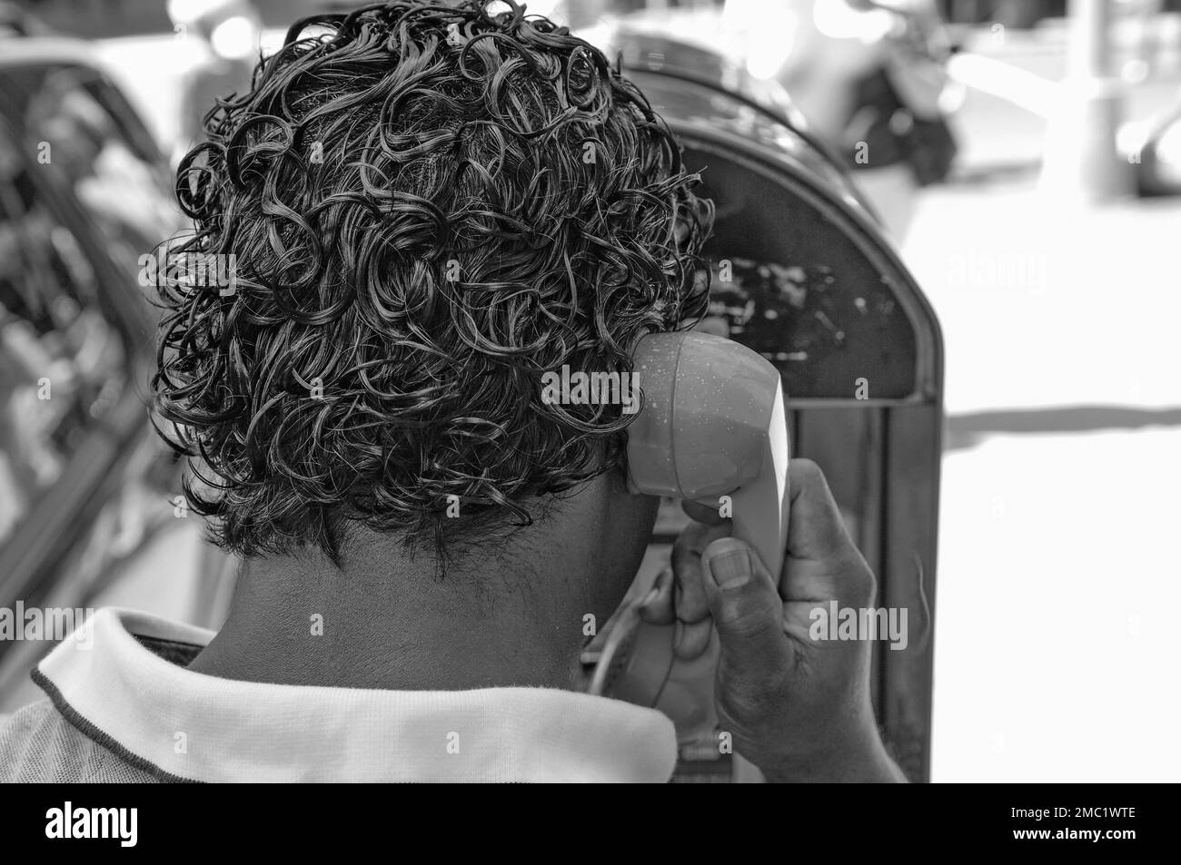 Black-haired New Yorker making a phone call at a telephone pillar, New ...