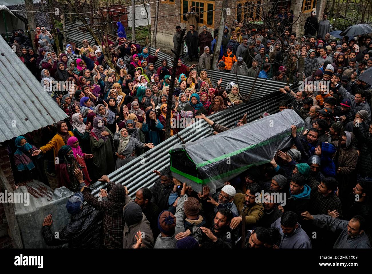 Family members and relatives mourn as they carry the body of Rafia ...
