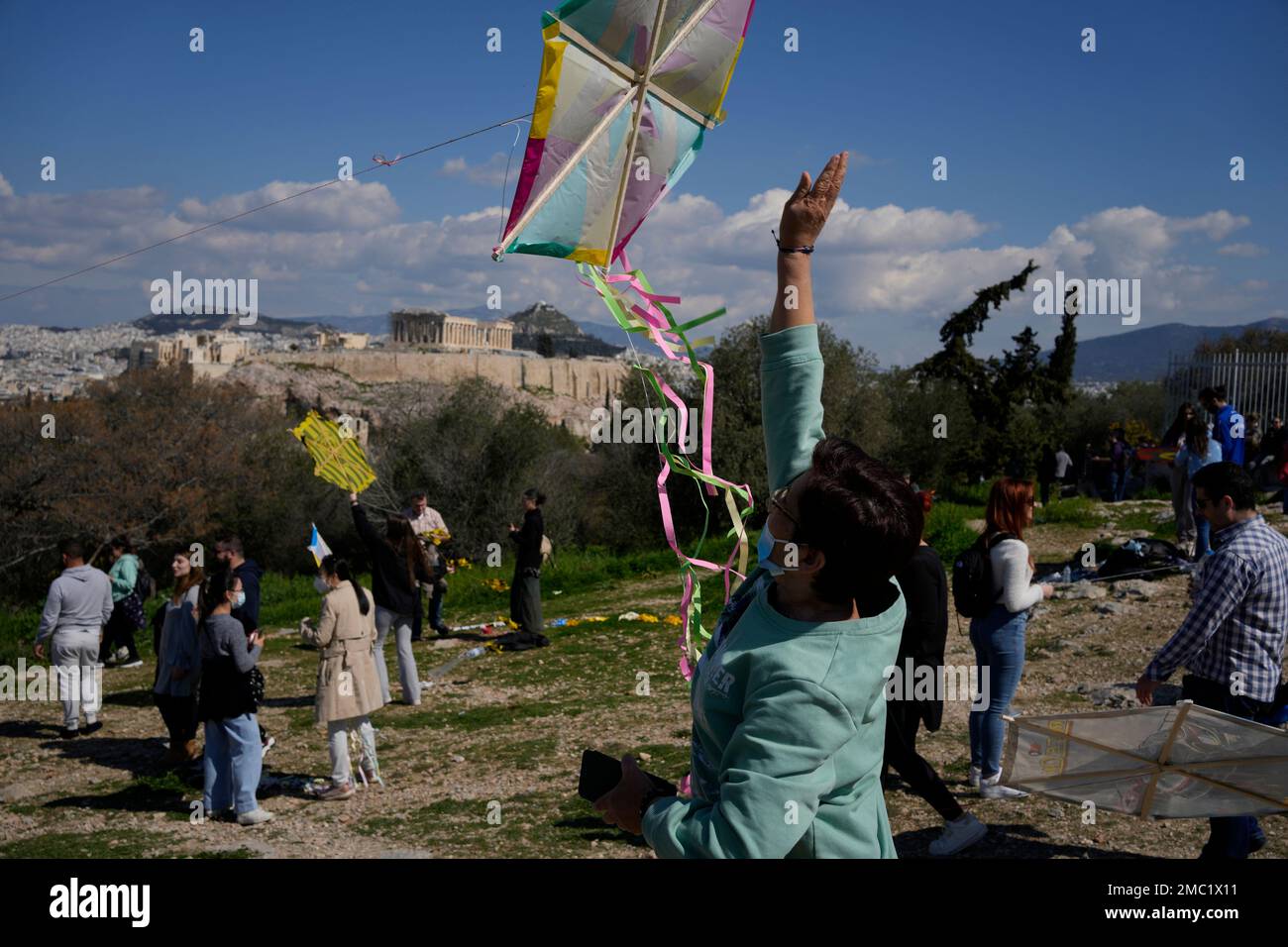 People try to fly kites as in the background stands the ancient ...