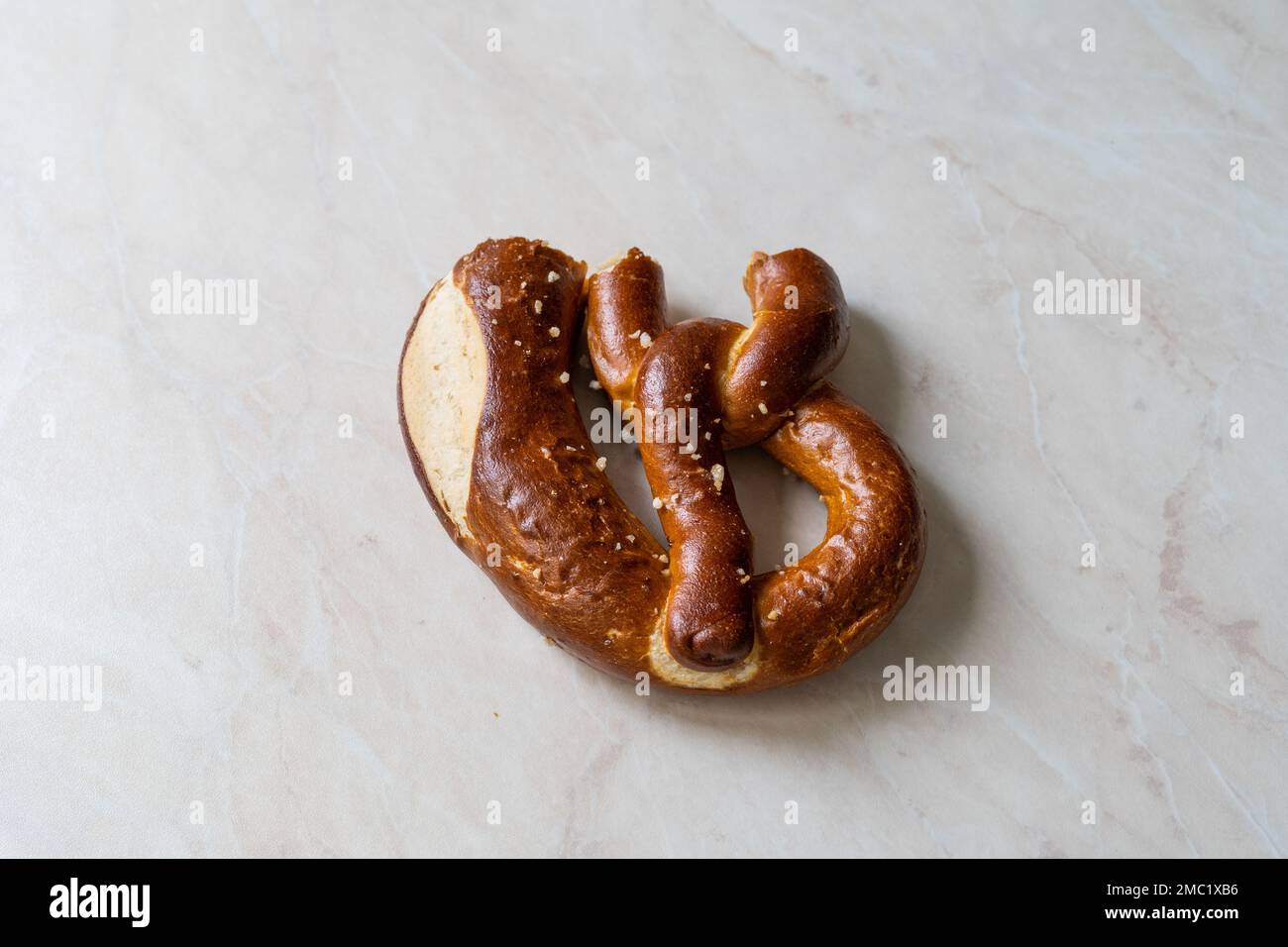 Bitten Leftover Pretzel on Marble Surface. Traditional Food Stock Photo ...