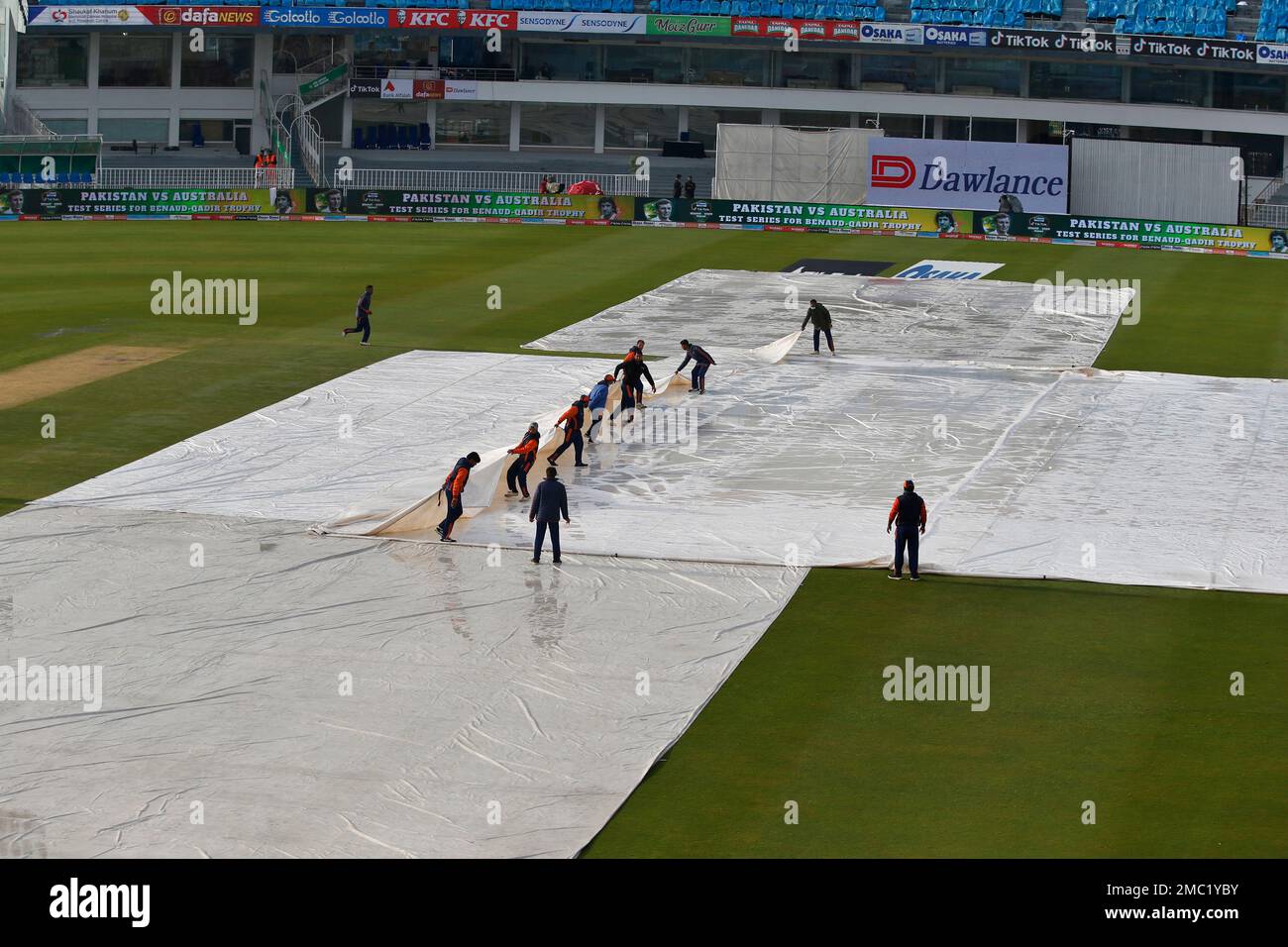Ground staff work to dry the field for start the 4th day play of first ...