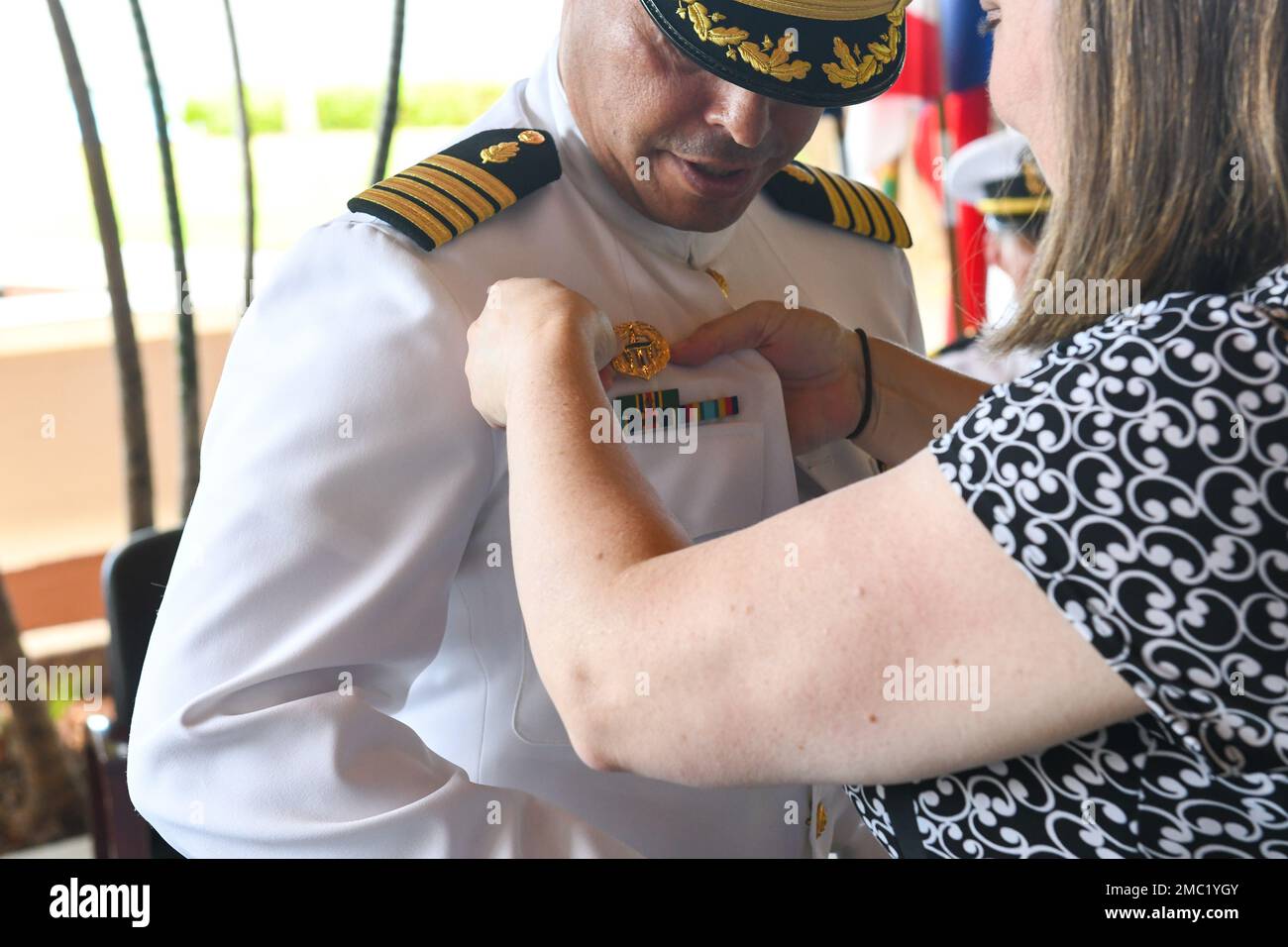 Mrs. Kristy Diaz places the command pin on Capt. Victor Diaz at the ...