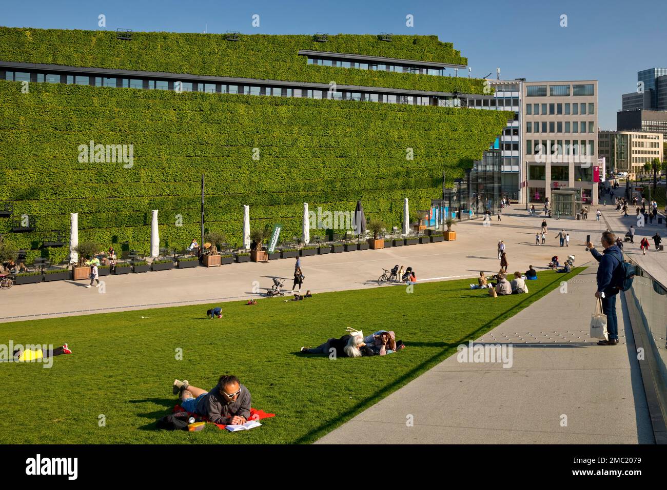 Green Ingenhoven valley with people, green architecture in the city ...