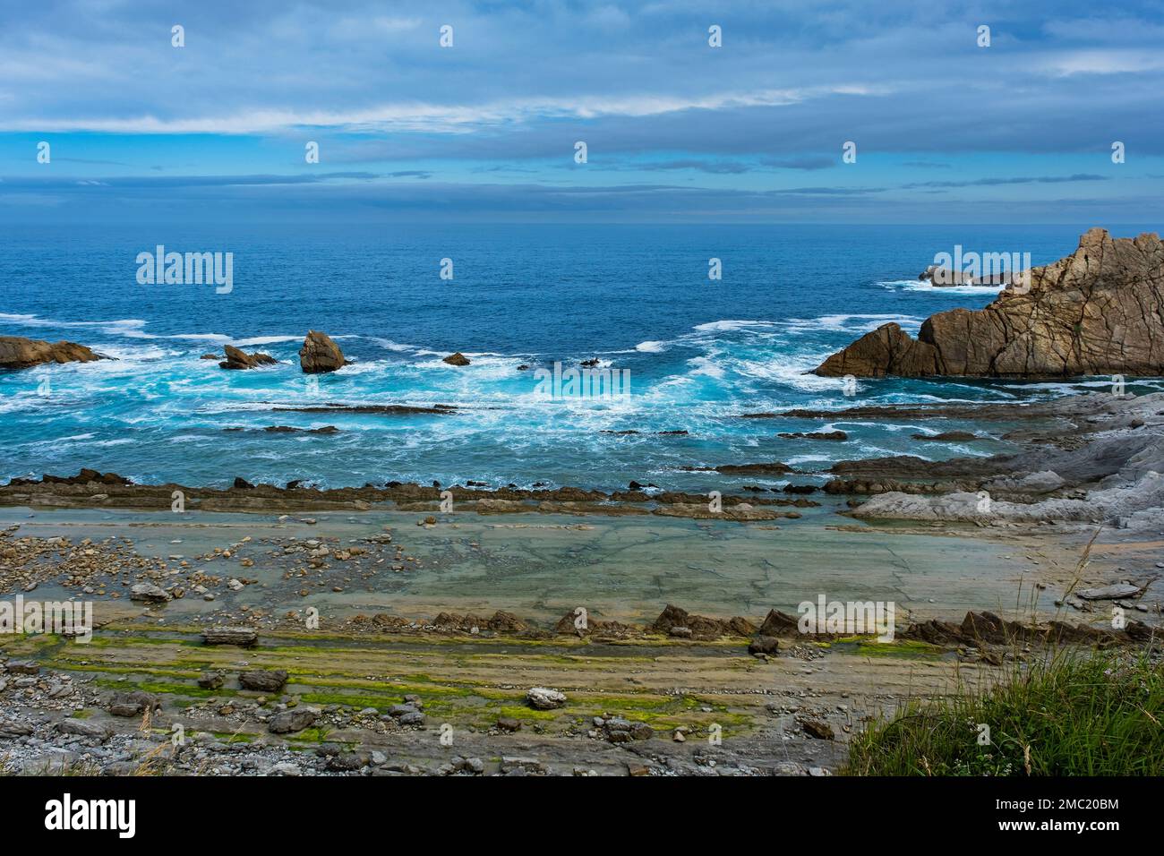 Abrasion platform in La Arnia beach, rocky coastline of Costa Quebrada ...