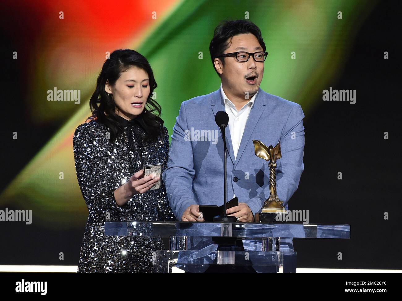 Teruhisa Yamamoto, right, accepts the award for best international film for "Drive My Car" at ...