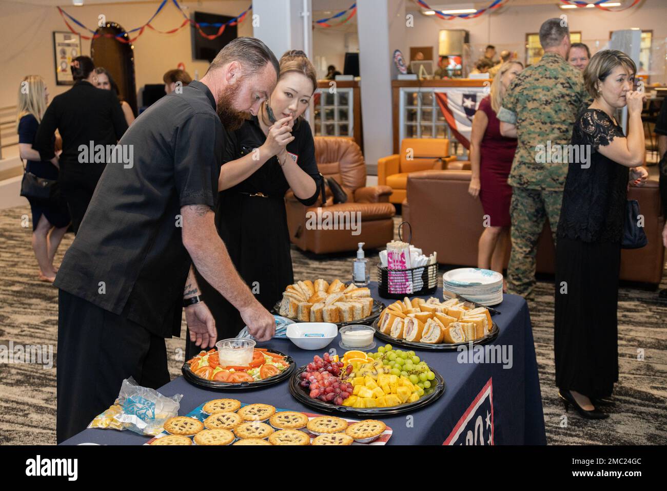 USO representatives and host nation employees prepare food during an ...