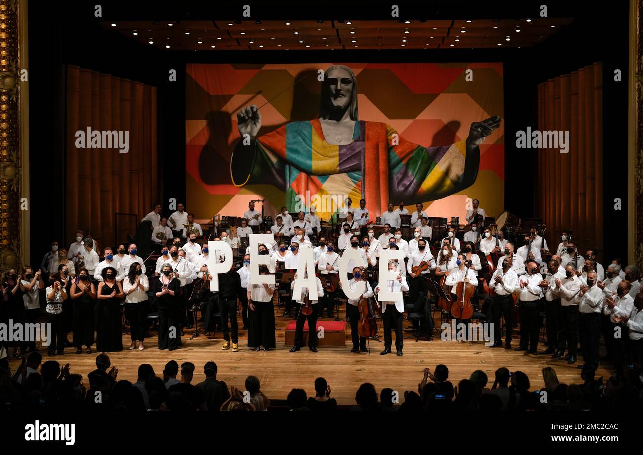Graffiti artist Eduardo Kobra, front left, and musicians hold letters ...