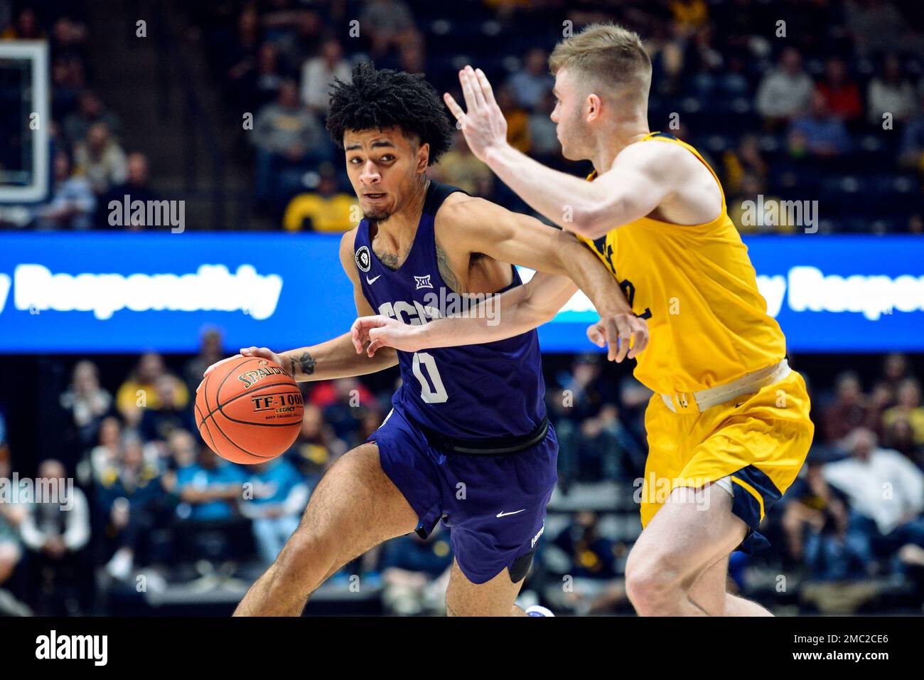 TCU guard Micah Peavy (0) protects the ball from West Virginia guard ...