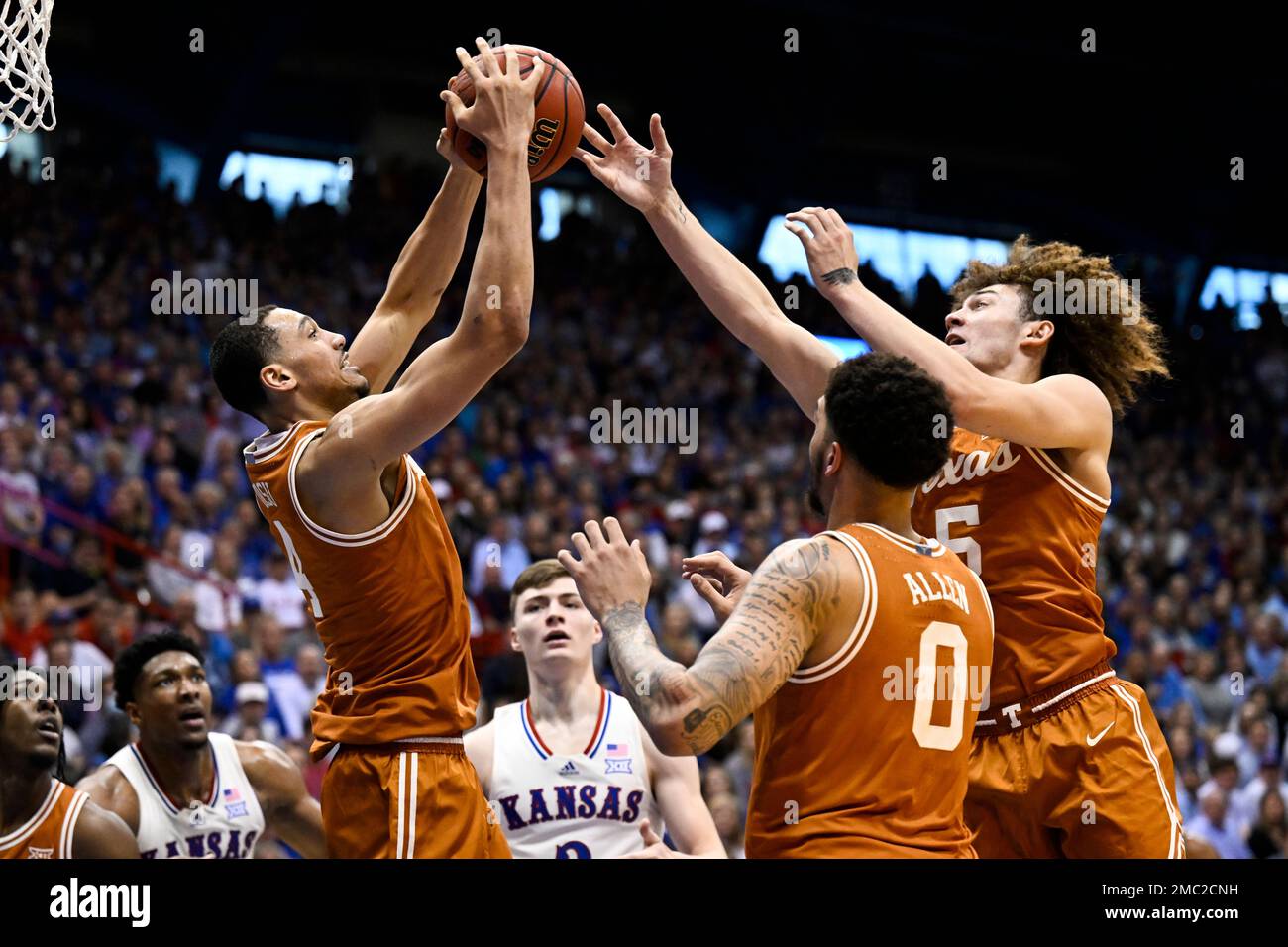 Texas forward Dylan Disu (4) pulls in a rebound in front of teammates ...