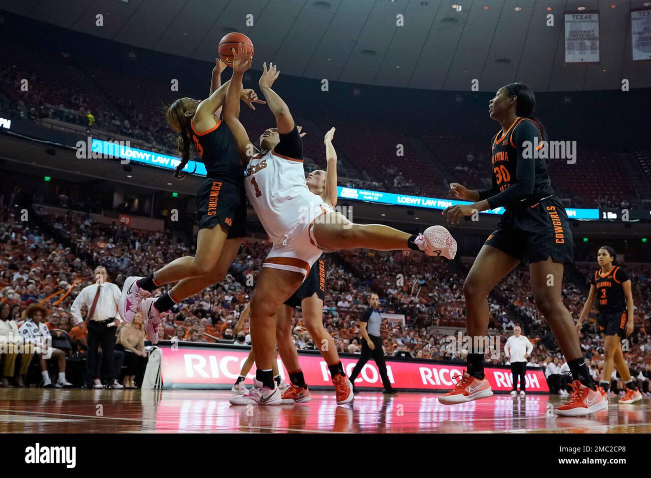Texas center Lauren Ebo (1) is fouled by Oklahoma State guard Lauren ...